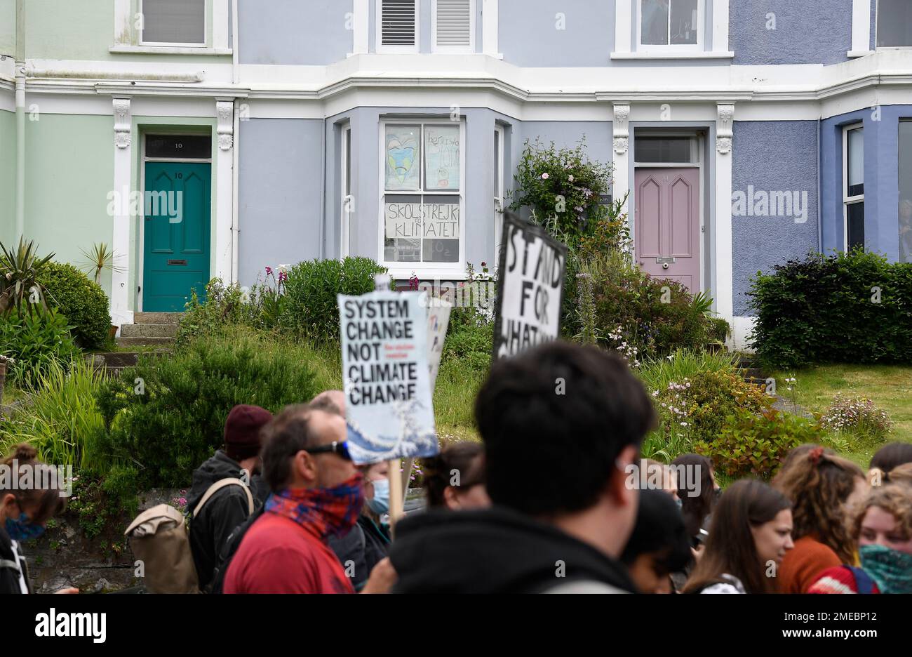 Climate activists wave signs as they march during a demonstration ...