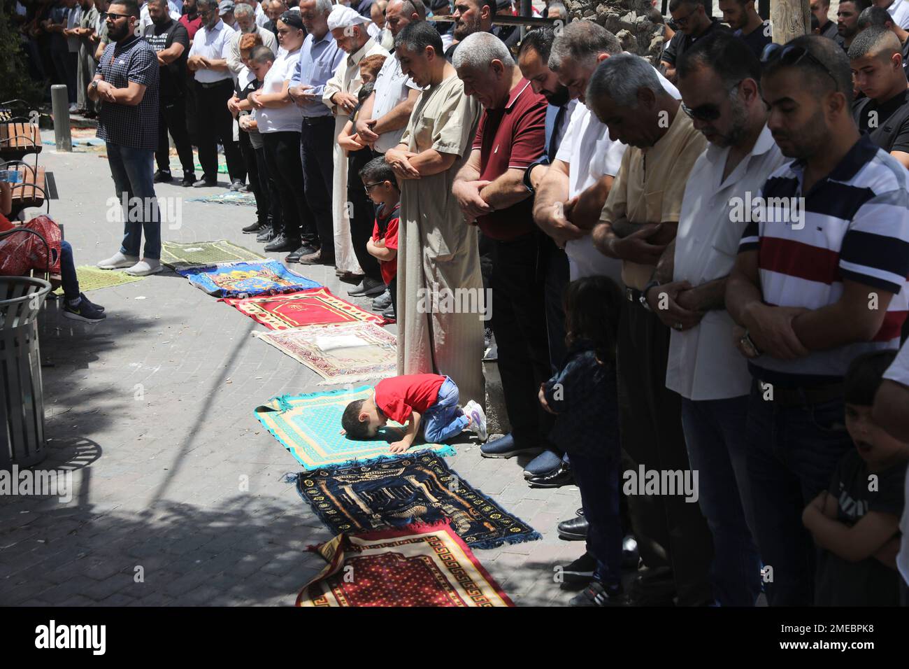 Worshippers take part in Friday prayers in the Silwan neighborhood of ...