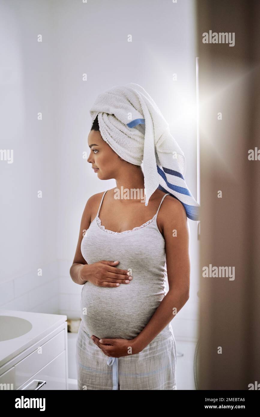 Pregnant women often have a natural glow about them. a pregnant young ...