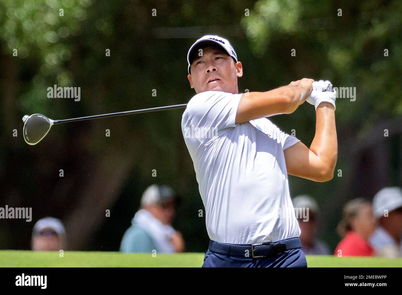 Xinjun Zhang, of China, watches is drive off the second tee during the ...