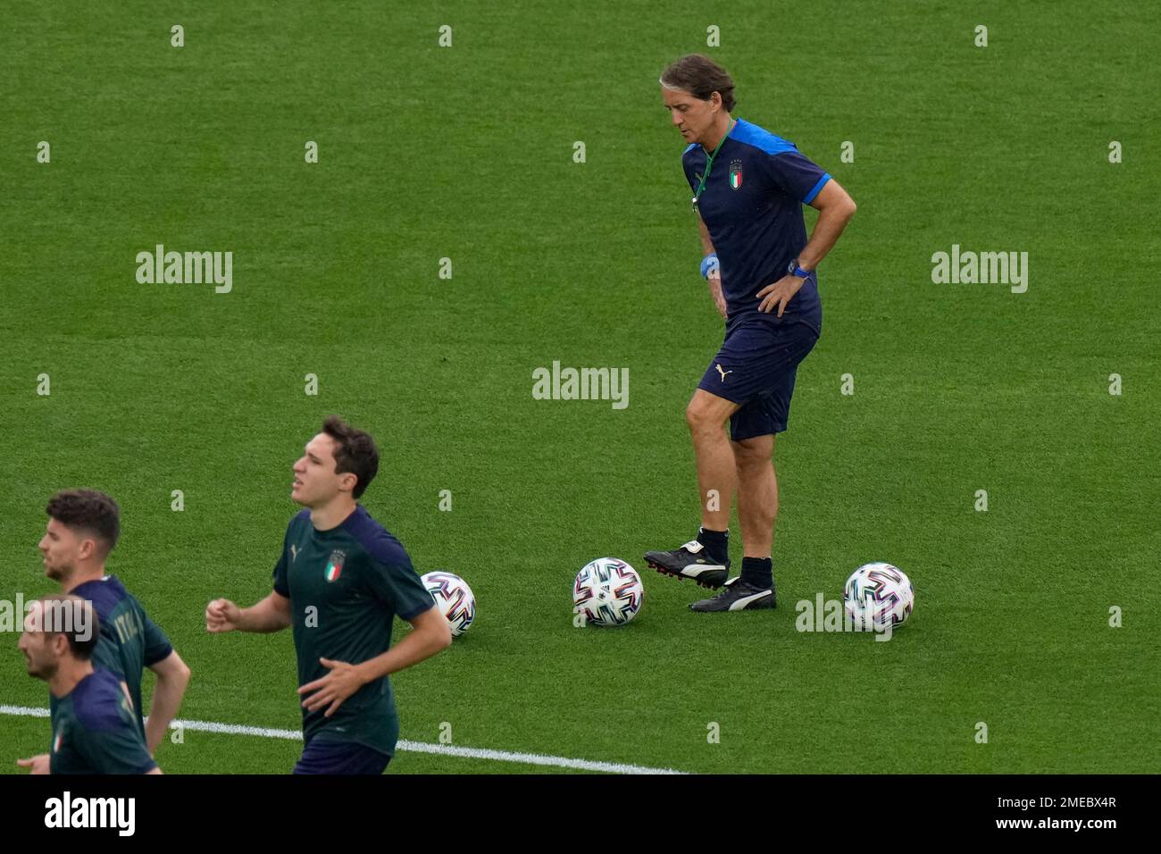 Italy's manager Roberto Mancini, top, leads a training session ahead of ...
