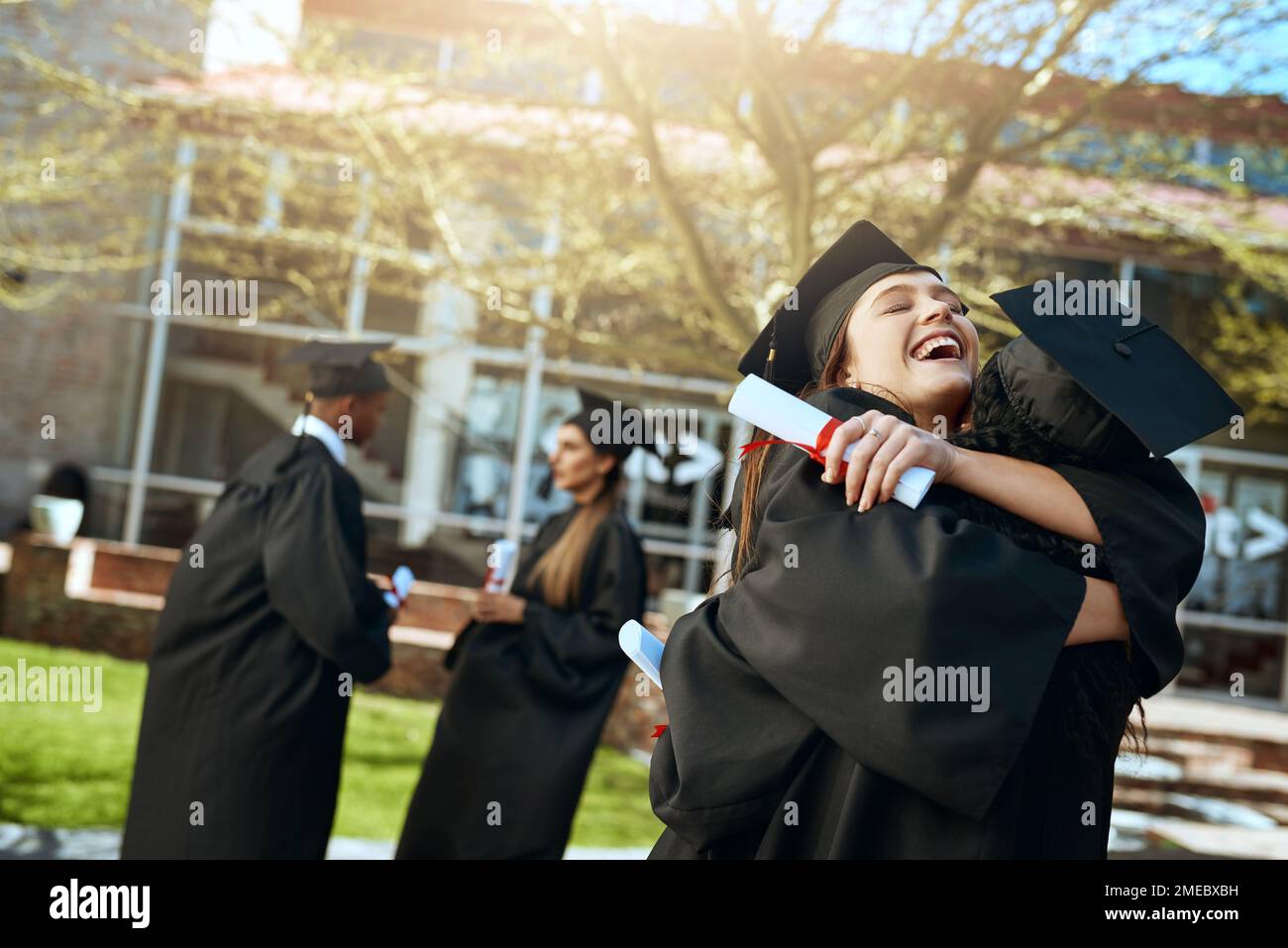 Success is even better when its shared. two happy young women hugging ...