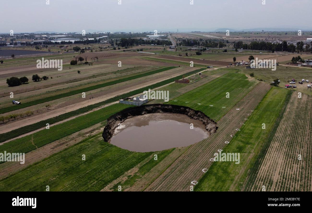 A water-filled sinkhole grows on a farming field in Zacatapec, on the ...