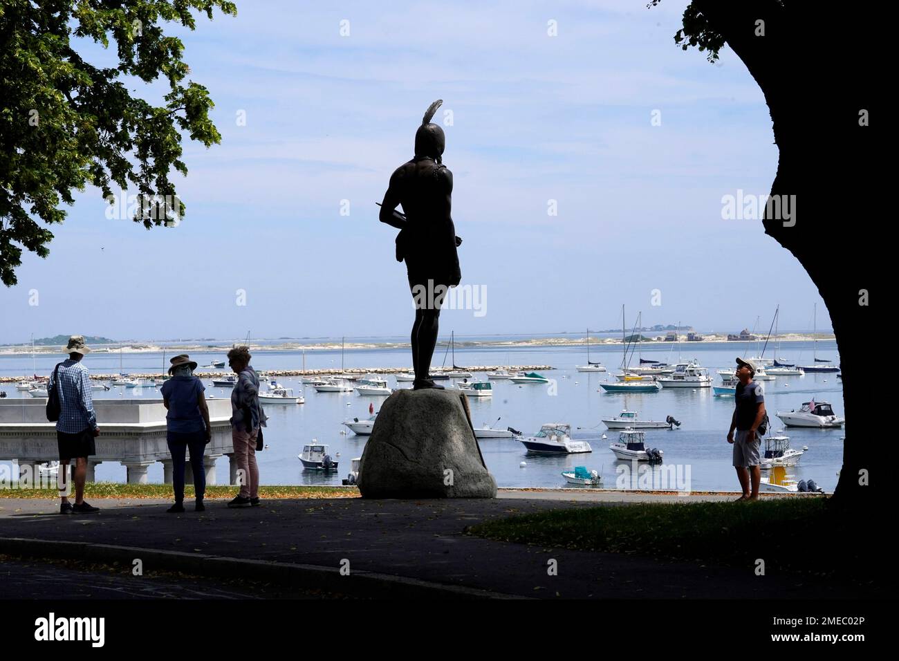 Visitors stand near a 1921 statue of the Wampanoag leader Massasoit ...