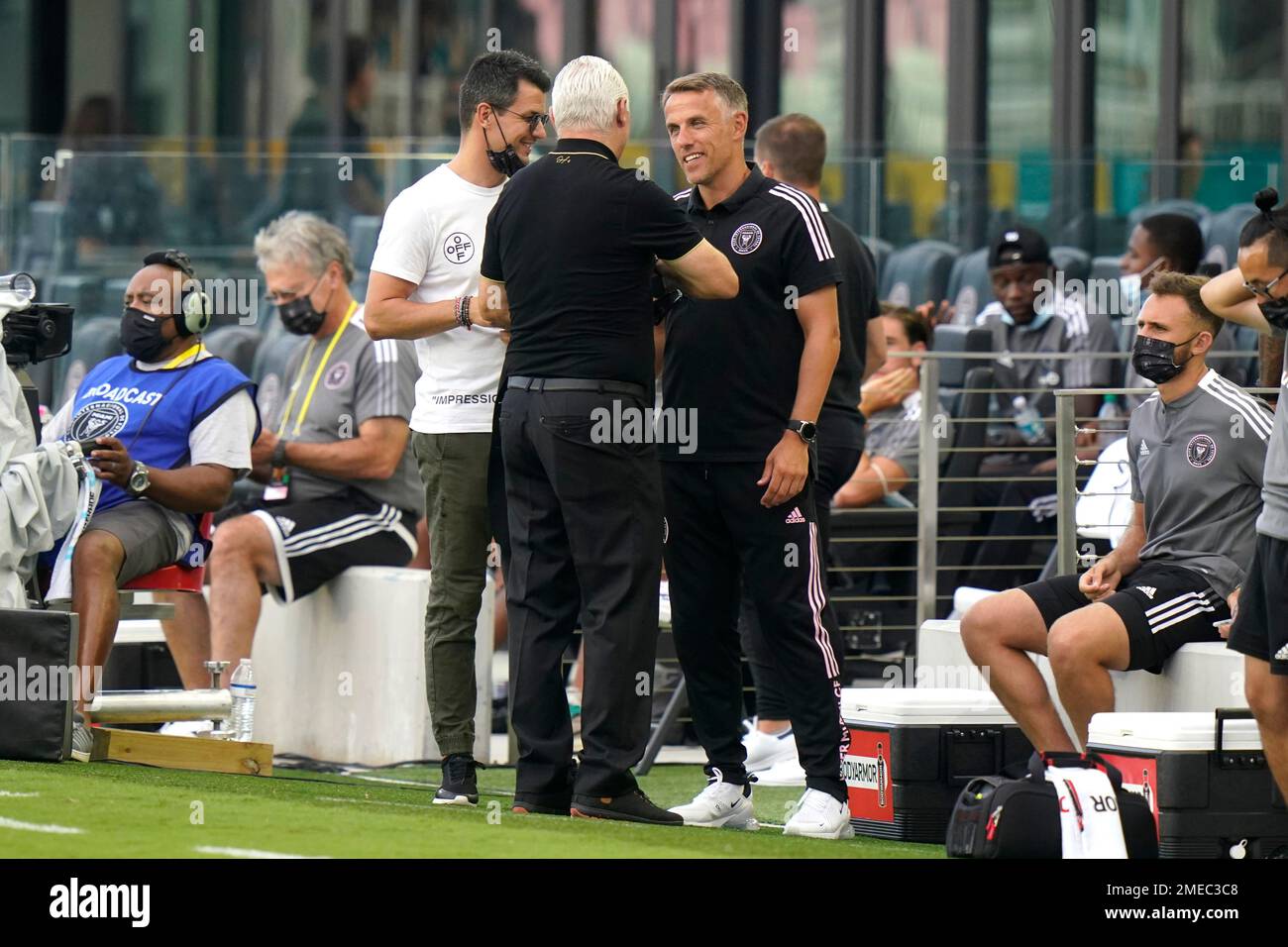 Inter Miami head coach Phil Neville, right, watches as the team warms ...