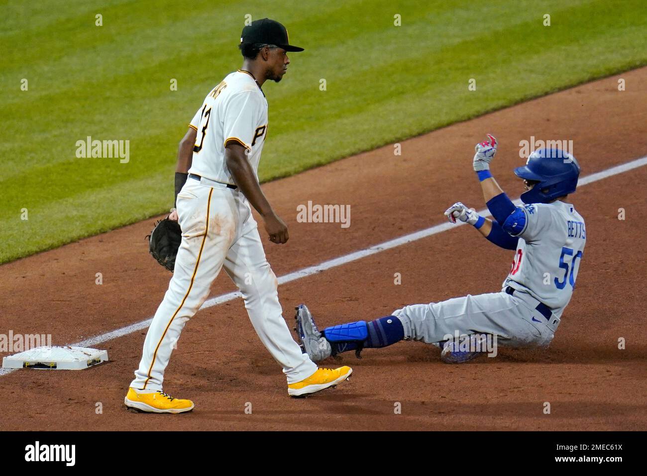 Los Angeles Dodgers' Mookie Betts (50) slides safely into third past ...