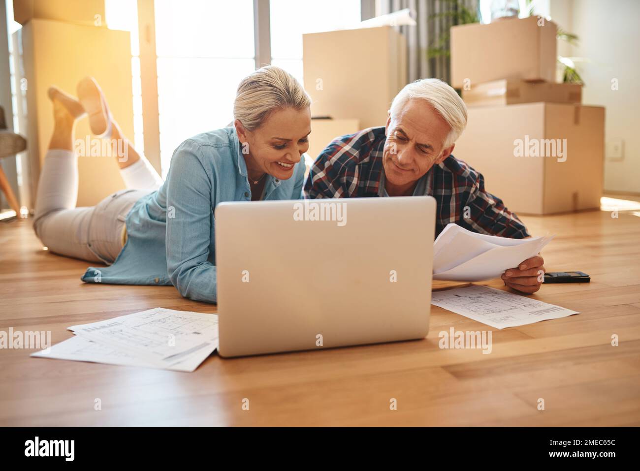Planning the layout of each room. a mature couple using a laptop and ...