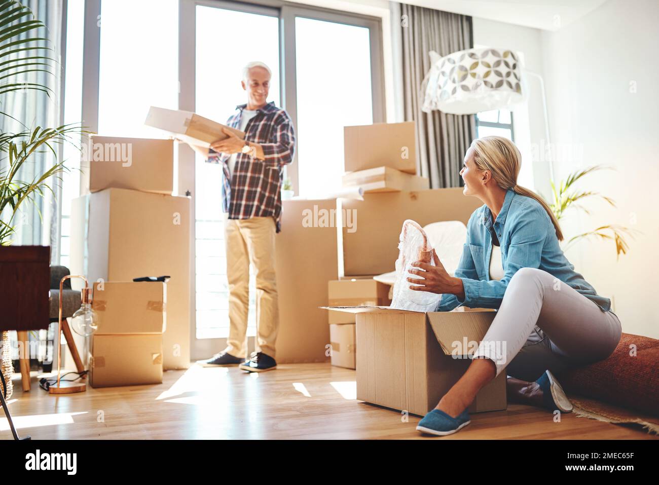 Remember the story behind this. a mature couple packing boxes on moving ...