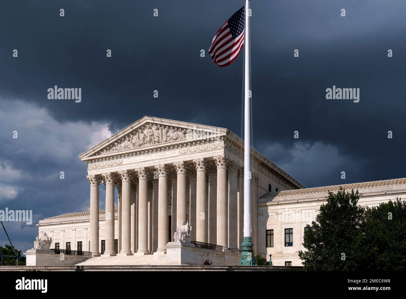 With dark clouds overhead, the Supreme Court is seen in Washington ...