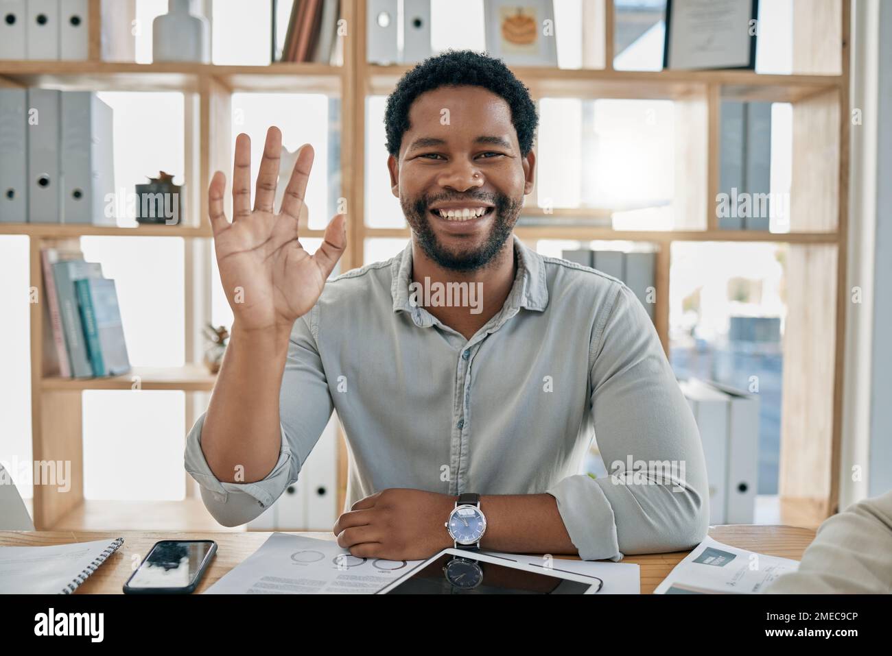 Business, video call and black man wave in office, conference or ...