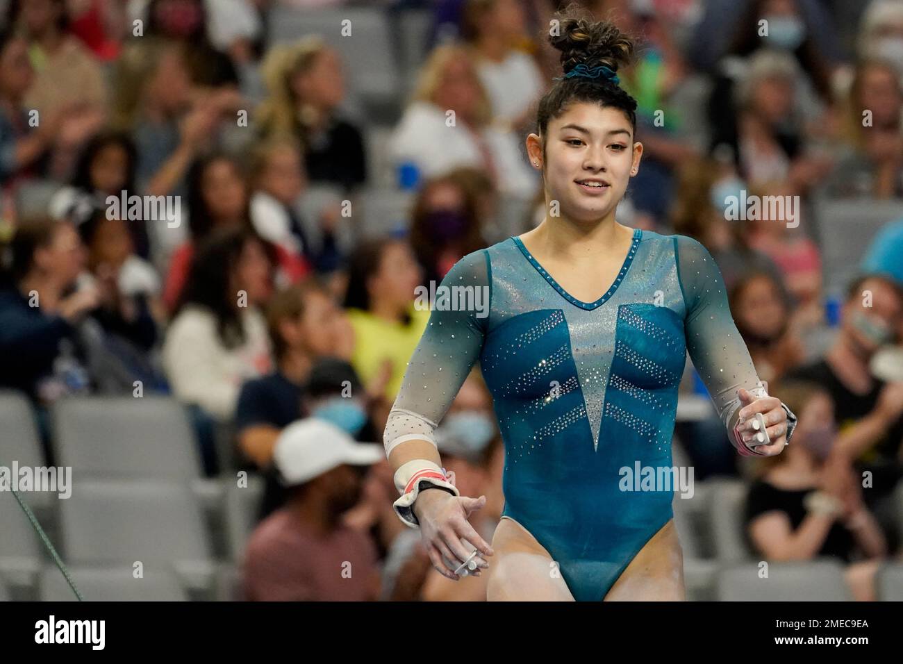 Kayla DiCello walks off the podium after competing on the uneven bars ...