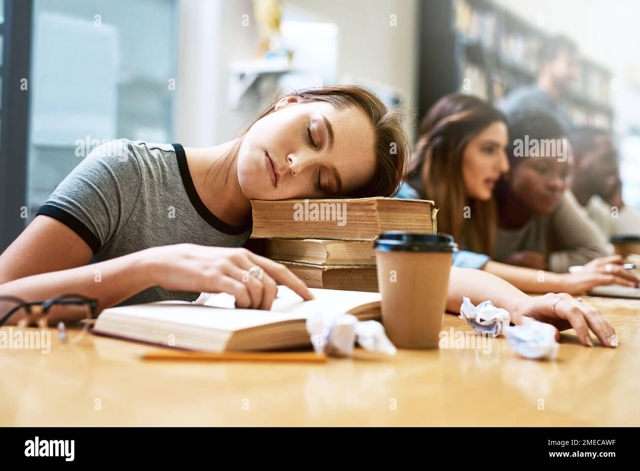 Prepping for finals got her like...a young woman looking tired while ...