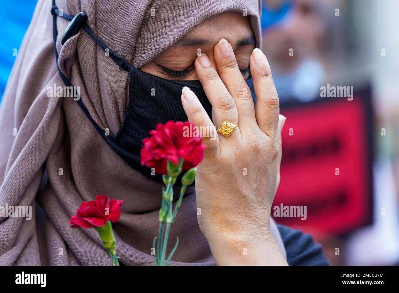 An activist pauses during a march and rally to demand the end of ...
