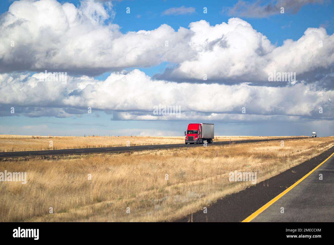 Industrial long hauler big rig red semi truck tractor with truck driver ...