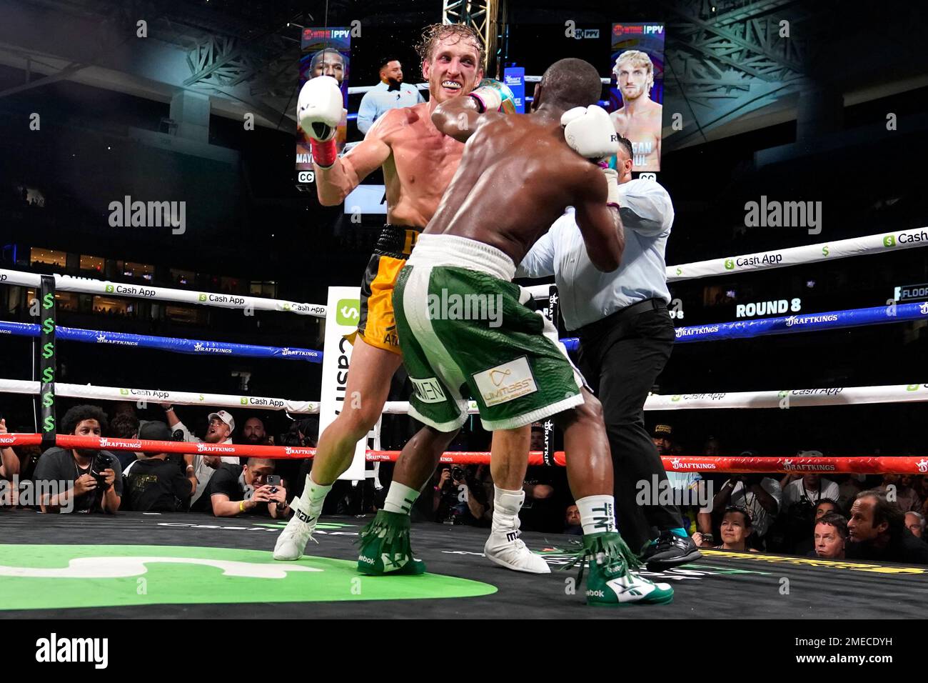 Logan Paul, left, and Floyd Mayweather, right, fight during an ...