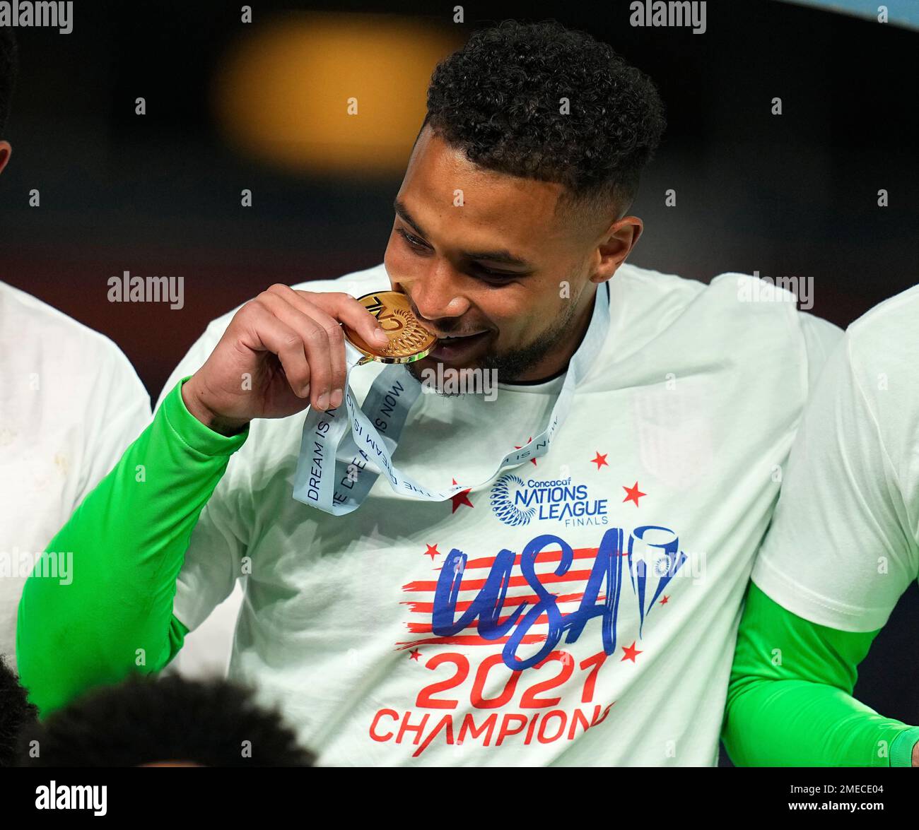 United States' Zack Steffen (1) bites his gold medal as he celebrates a ...