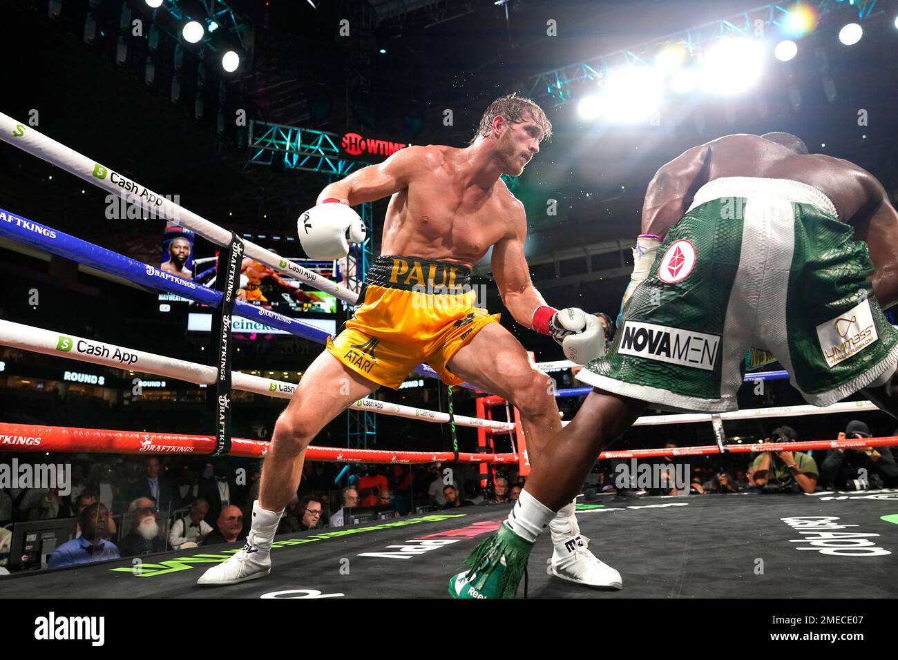 Logan Paul, left, and Floyd Mayweather, right, fight during an ...