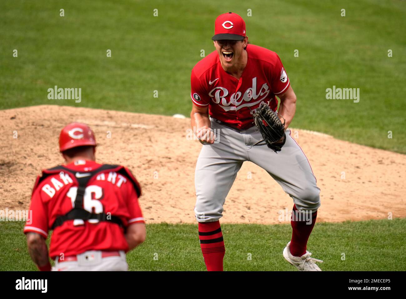 Cincinnati Reds pitcher Lucas Sims, right, and catcher Tucker Barnhart ...