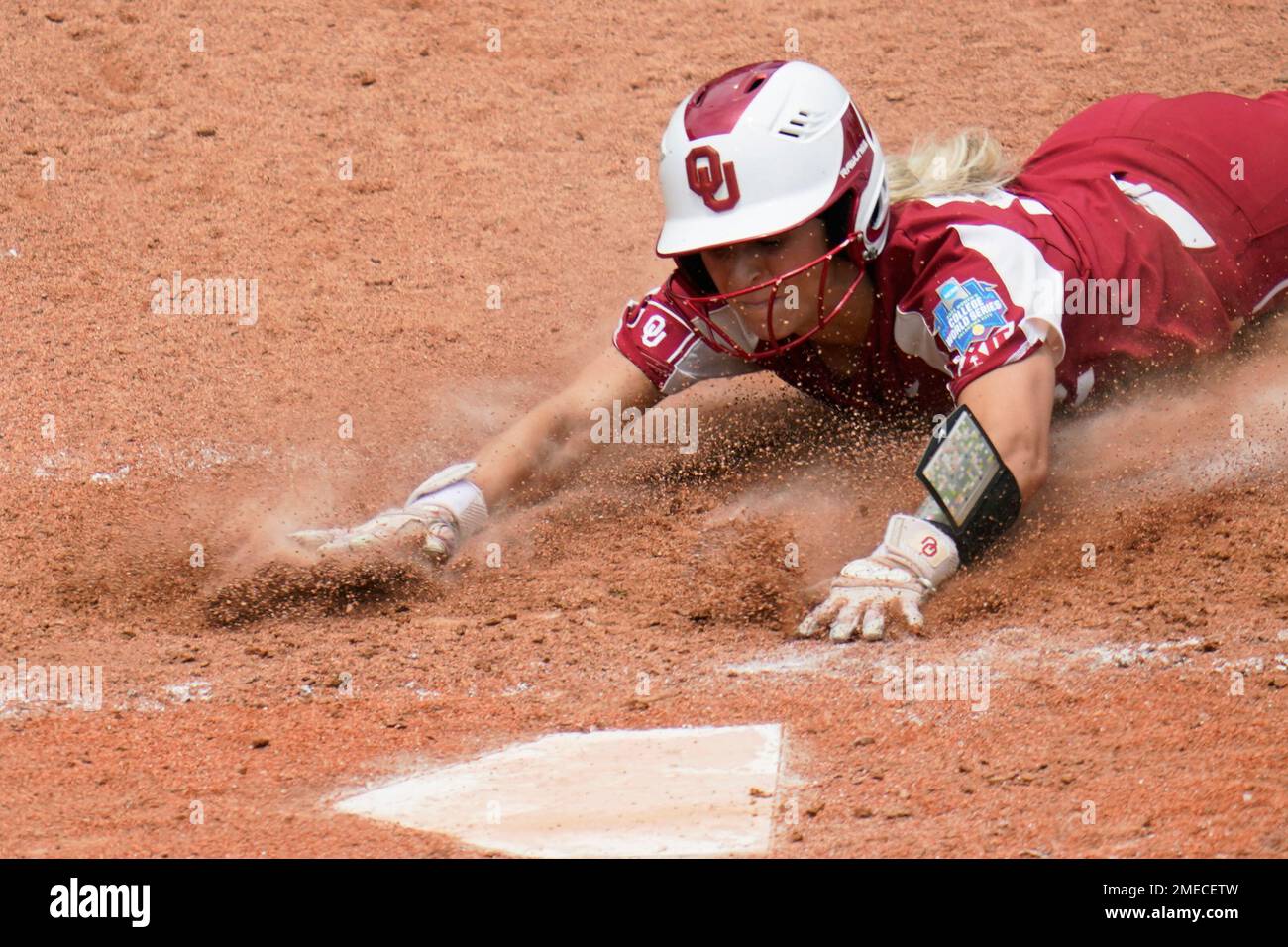 Oklahoma's Mackenzie Donihoo scores on a ball hit by Oklahoma's Nicole ...