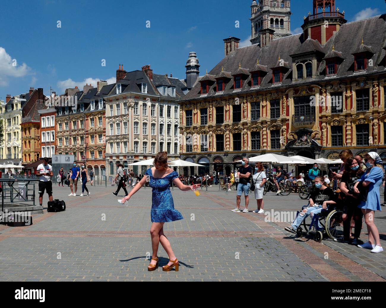 A women dances by a cafe terrace in Lille, northern France, Sunday ...
