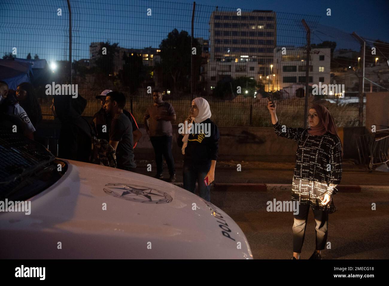 Palestinian activist Muna al-Kurd, center, walks with other activists ...
