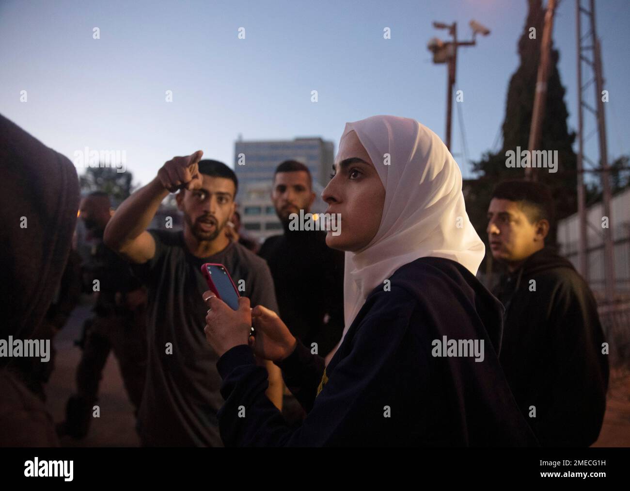 Palestinian activist Muna al-Kurd, center, stands with other activists ...