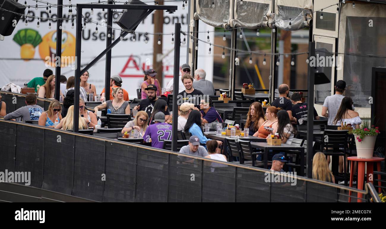 Unmasked diners sit on a rooftop terrace early Sunday, June 6, 2021, in ...