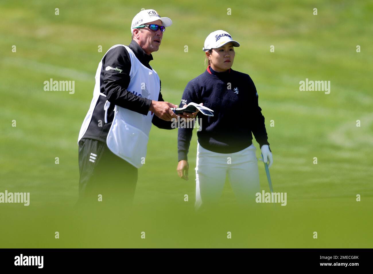 Nasa Hataoka, of Japan, reads her shot with her caddy on the first ...