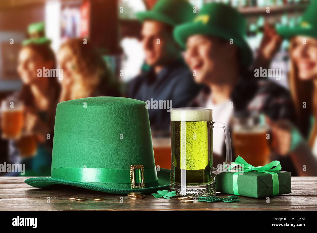 Leprechaun's hat, gift and glass of beer on table in bar. St. Patrick's ...
