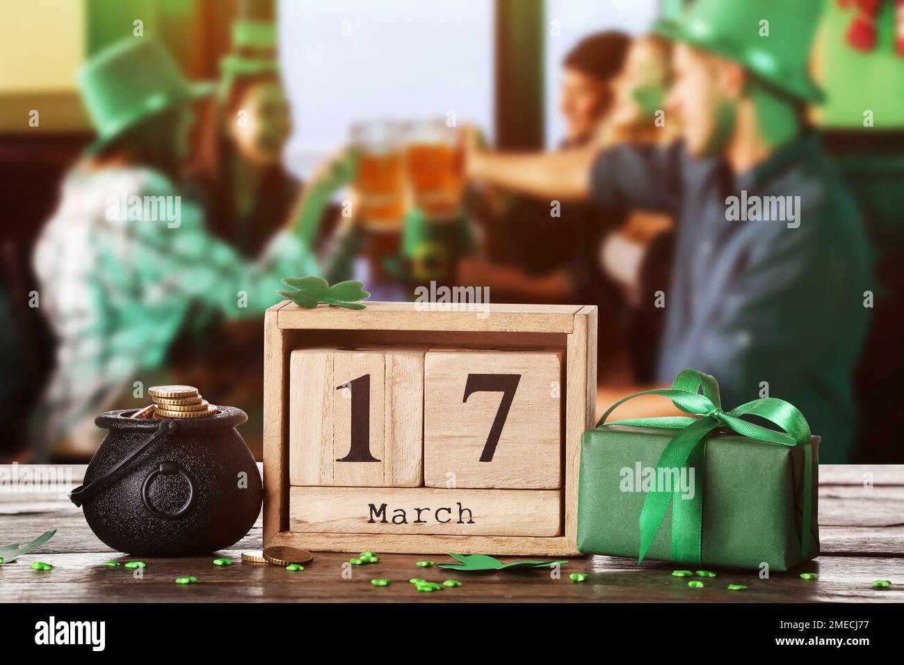 Pot with coins, calendar with date of St. Patrick's Day and gift on ...
