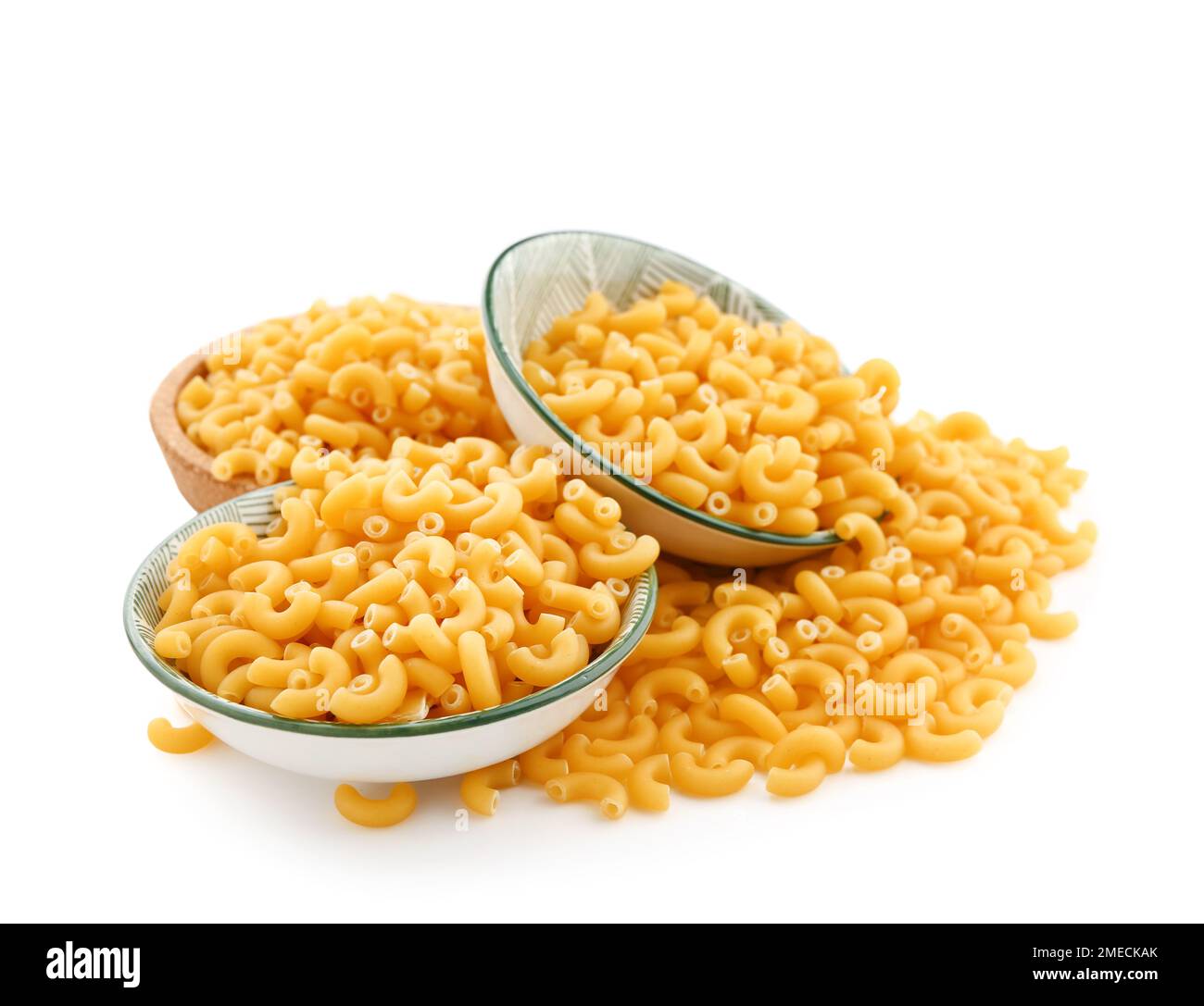 Bowls of raw elbow pasta isolated on white background Stock Photo - Alamy