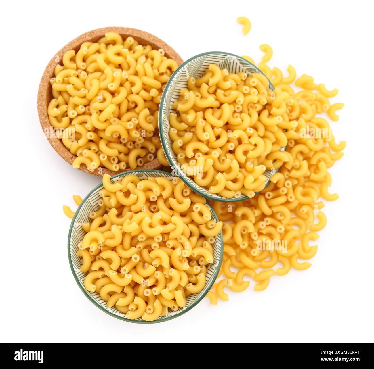 Bowls of raw elbow pasta isolated on white background Stock Photo - Alamy