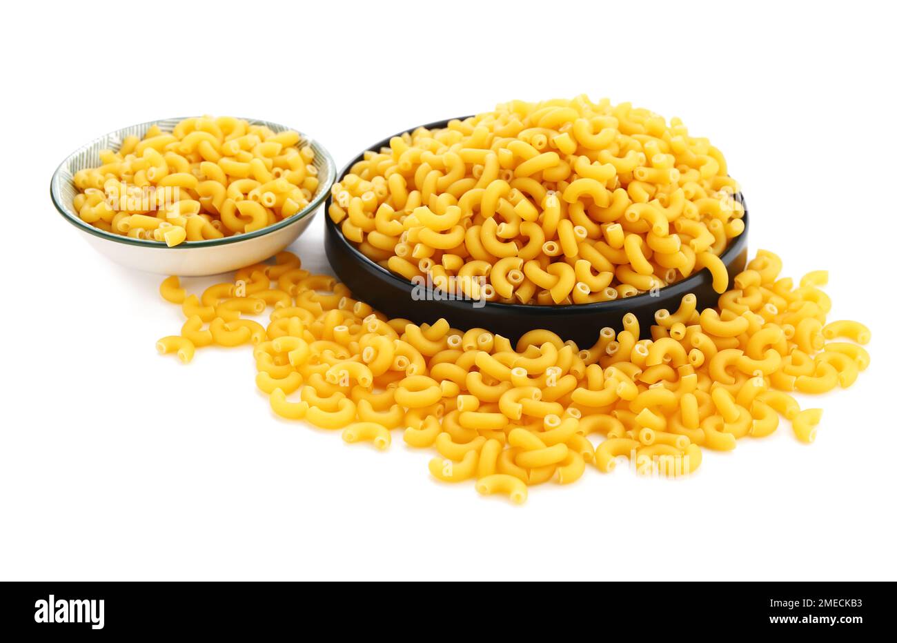 Plates of raw elbow pasta isolated on white background Stock Photo - Alamy