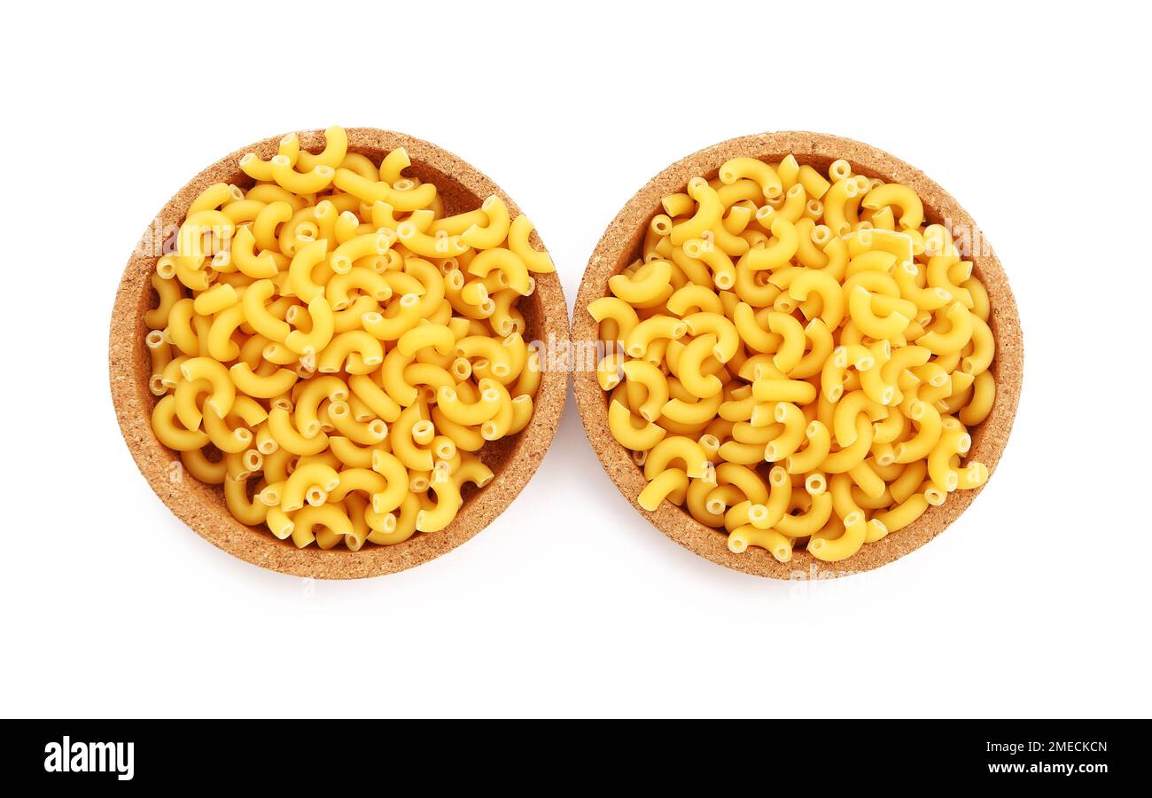 Plates of raw elbow pasta on white background Stock Photo - Alamy