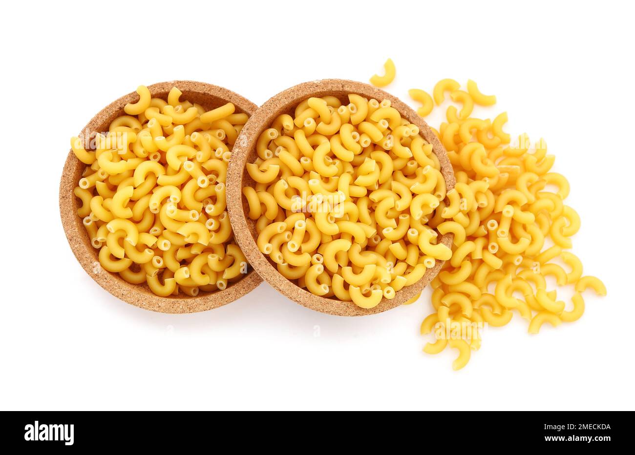 Plates of raw elbow pasta on white background Stock Photo - Alamy