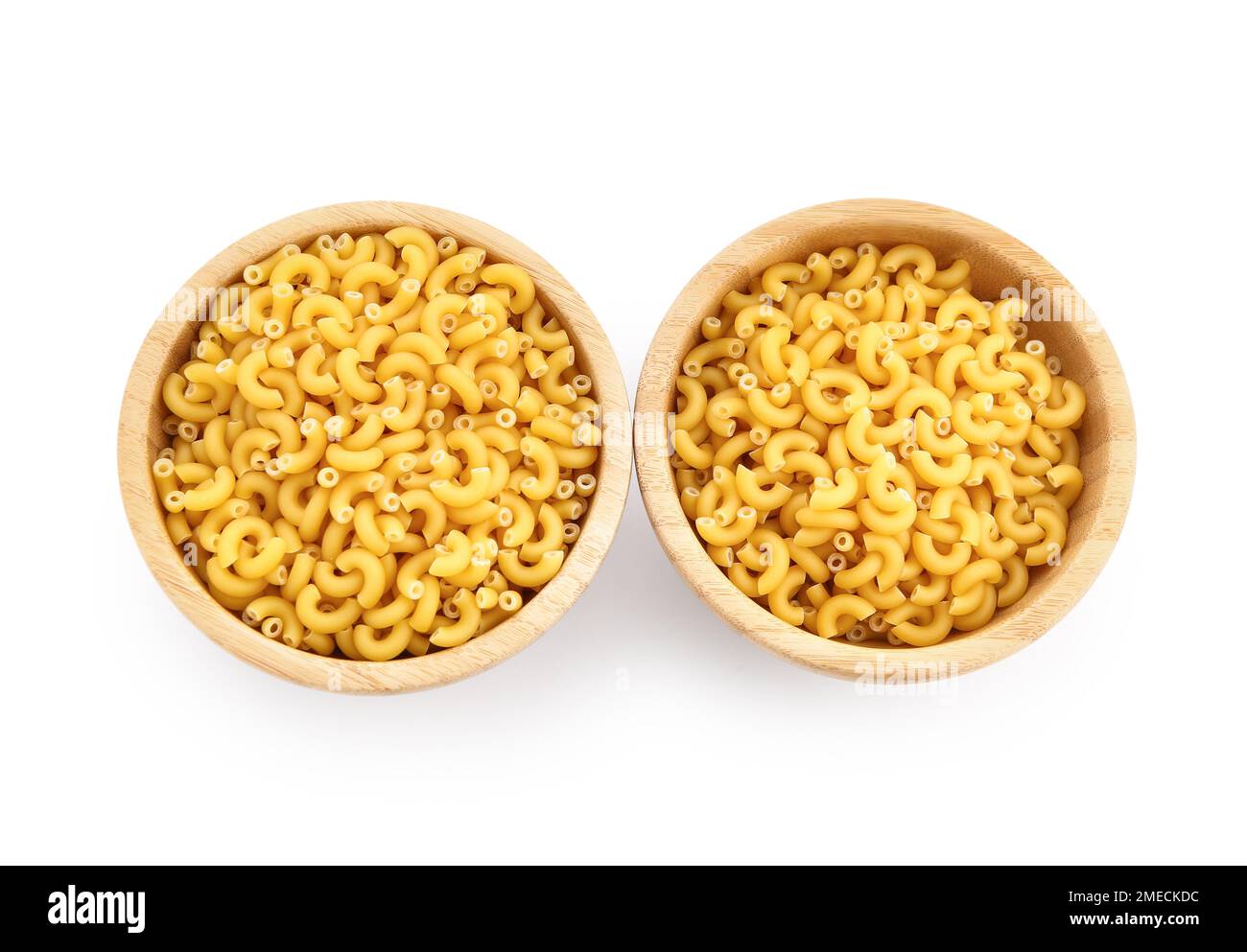 Wooden bowls of raw elbow pasta on white background Stock Photo - Alamy