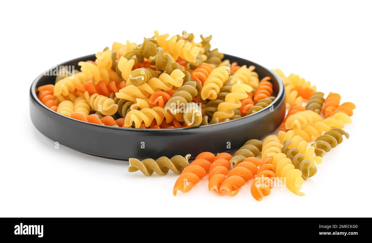 Plate of raw fusilli pasta on white background Stock Photo - Alamy
