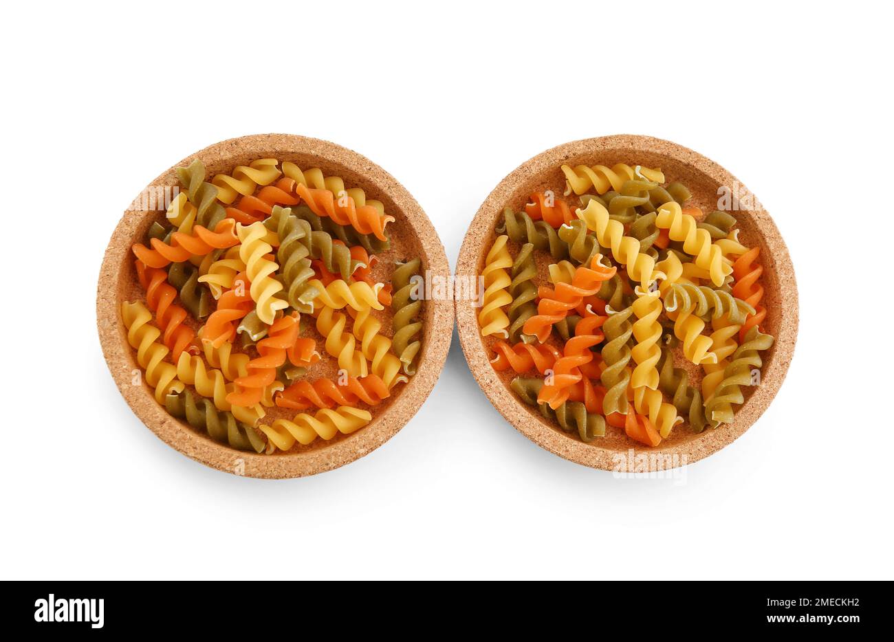 Plates of raw fusilli pasta on white background Stock Photo - Alamy