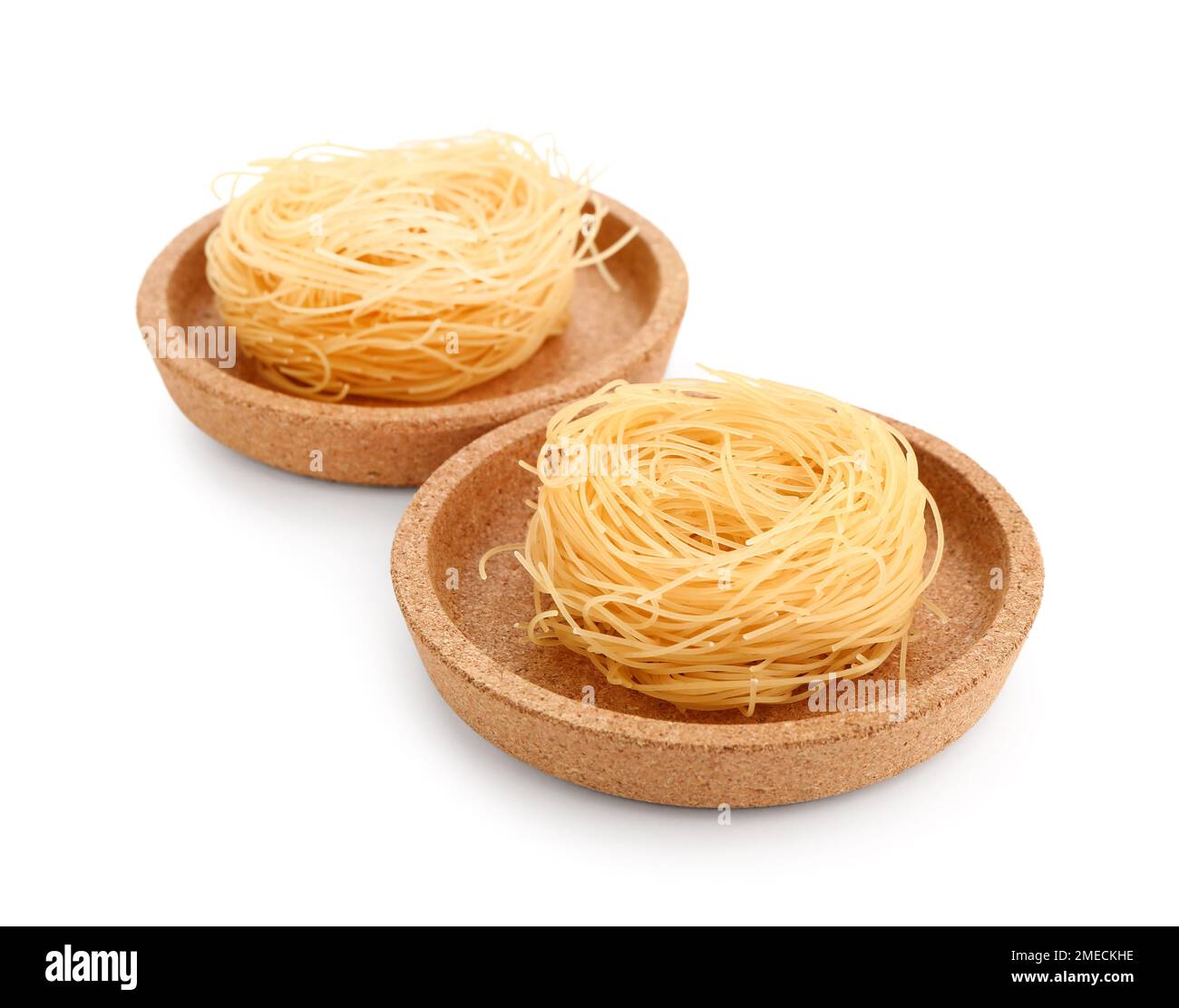 Plates of raw pasta nests on white background Stock Photo - Alamy