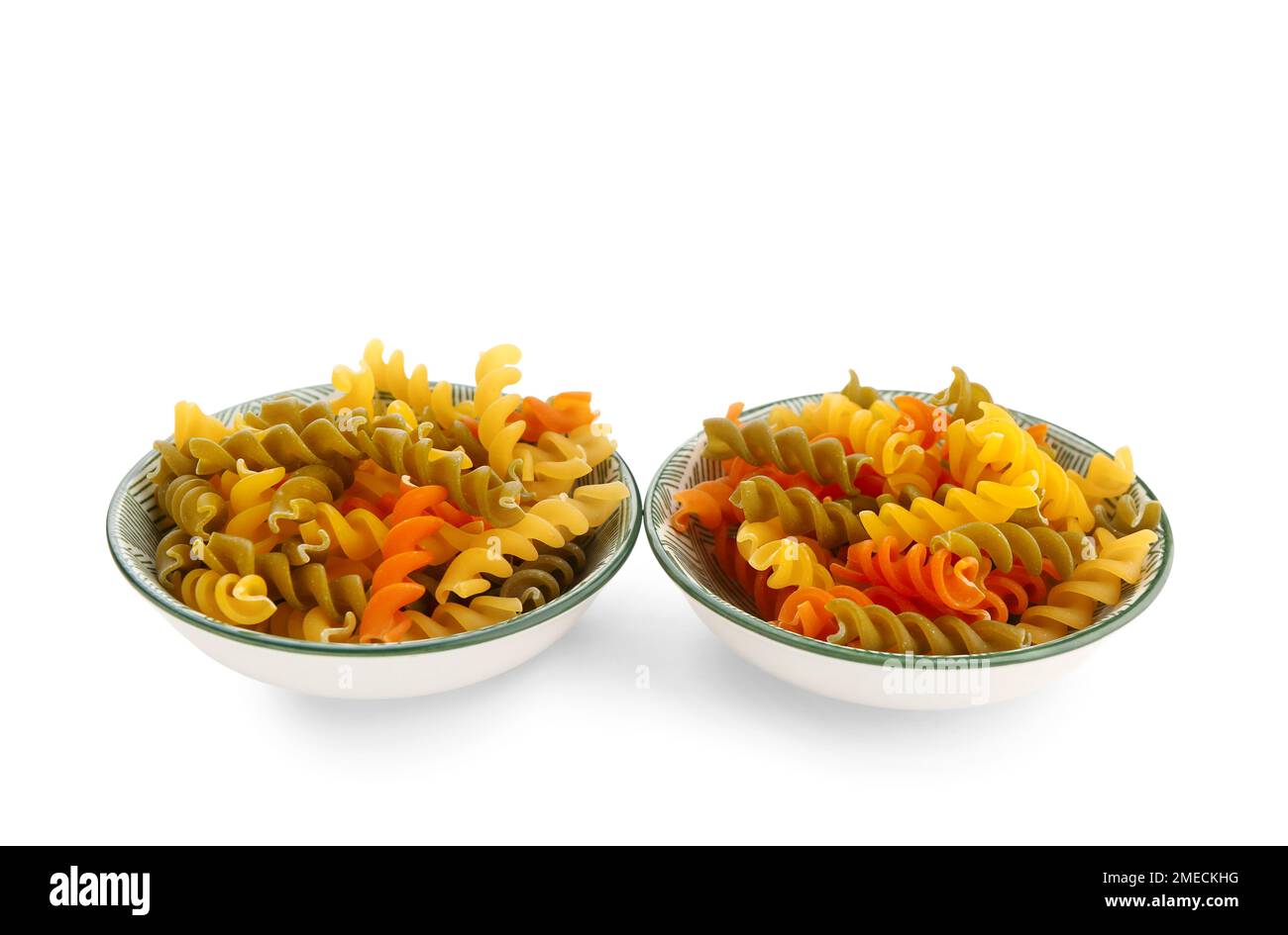 Bowls of raw fusilli pasta isolated on white background Stock Photo - Alamy