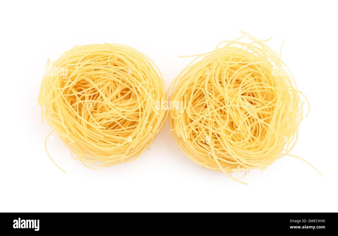 Raw pasta nests on white background Stock Photo - Alamy
