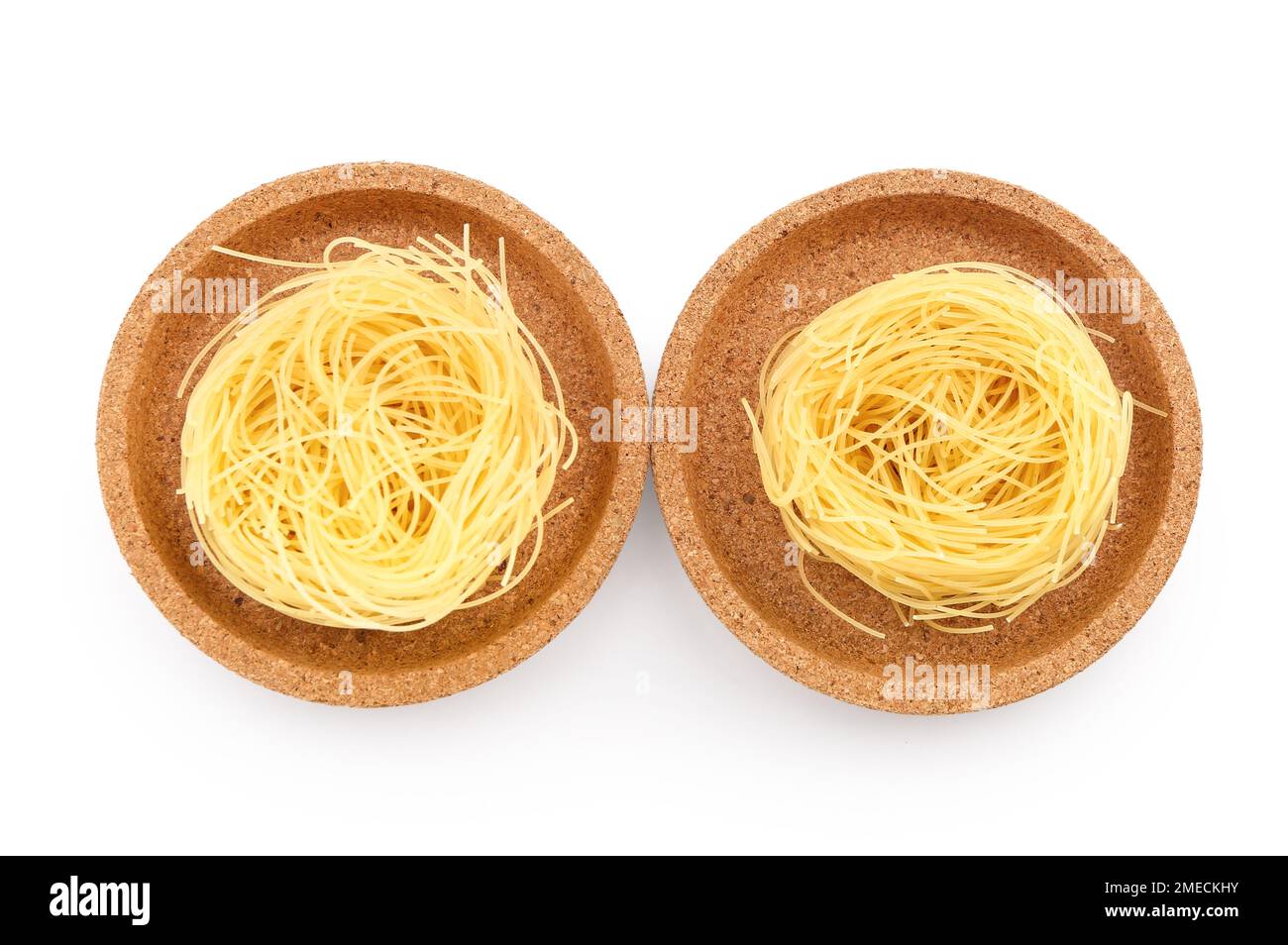 Plates of raw pasta nests on white background Stock Photo - Alamy