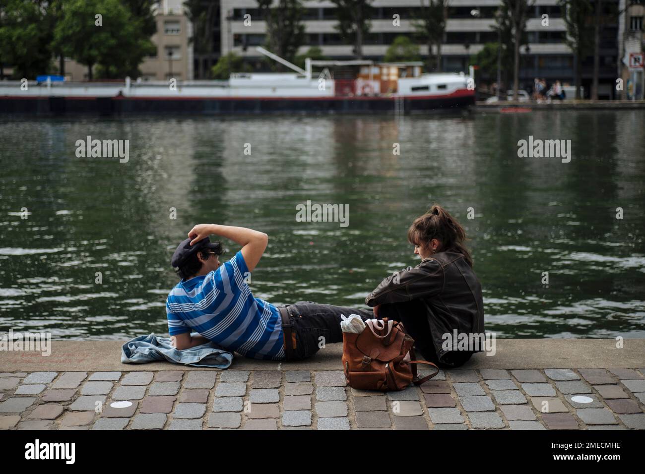 People sunbath by the Bassin de la Villette Canal, in Paris, France ...