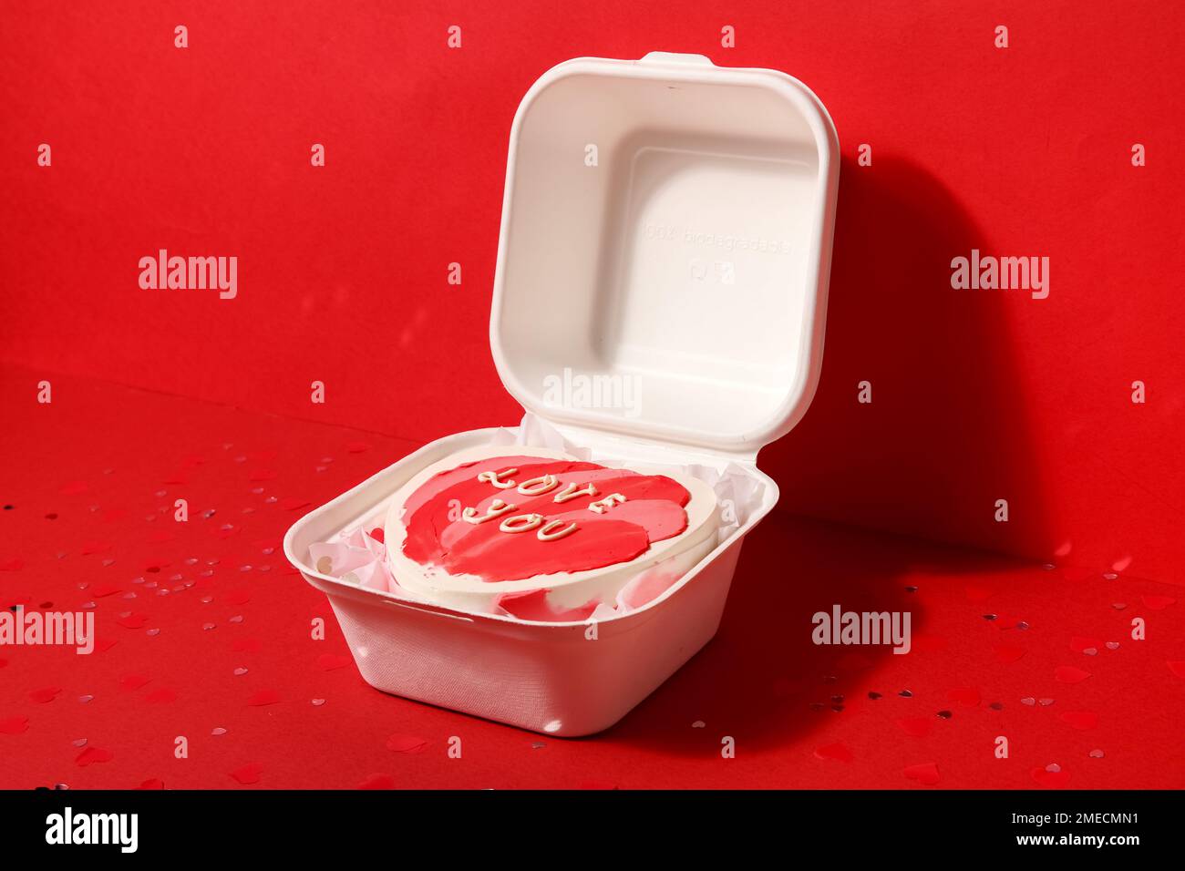 Lunch box with heart-shaped bento cake for Valentine's Day on red ...
