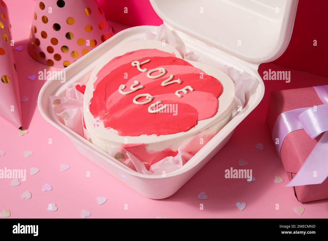 Lunch box with bento cake, party hats and gift for Valentine's Day on ...