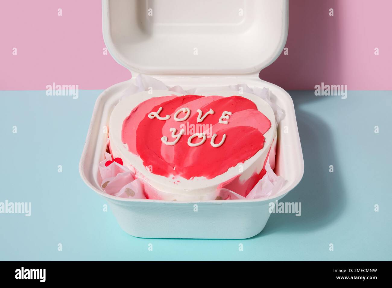 Lunch box with heart-shaped bento cake for Valentine's Day on table ...