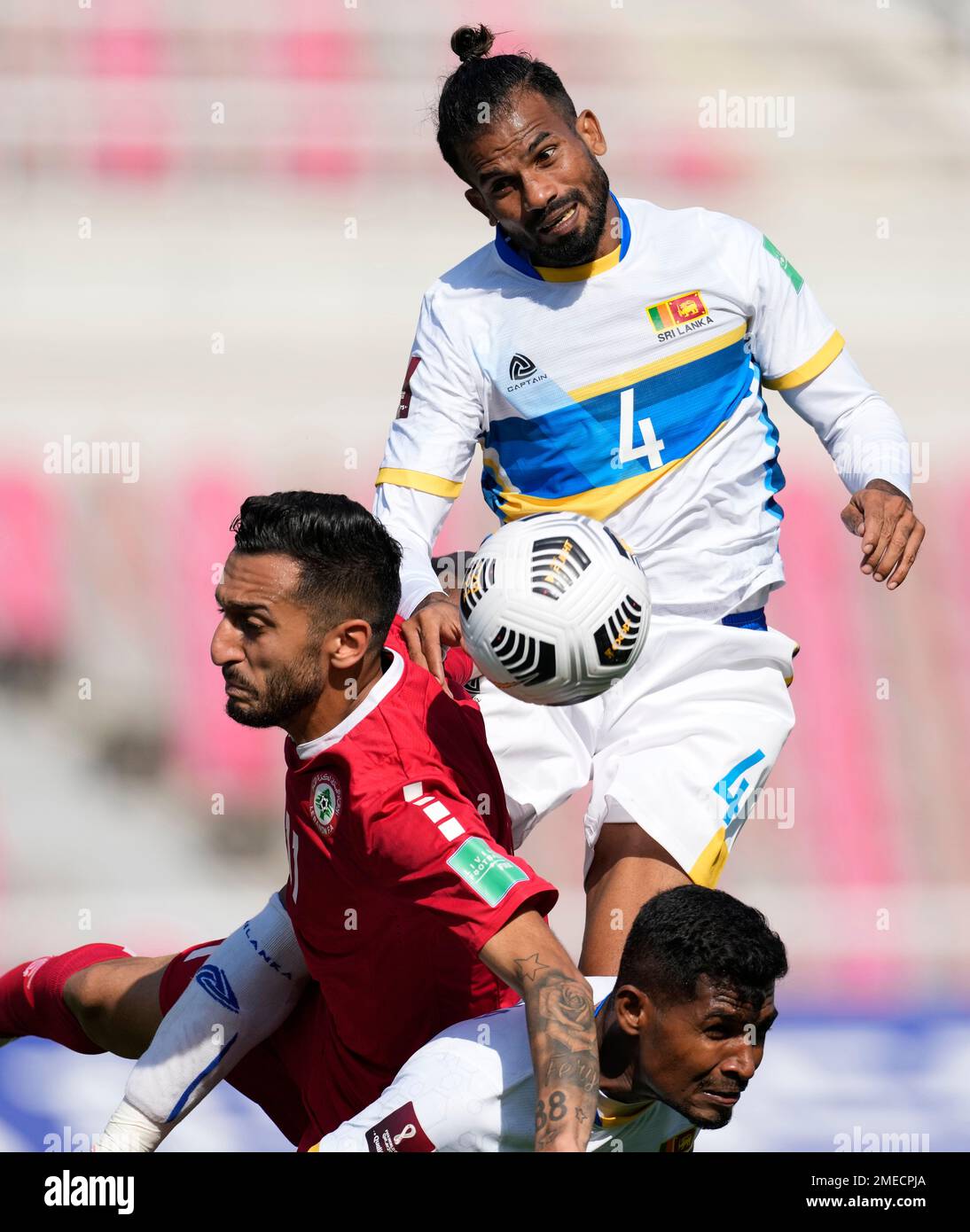 Sri Lanka's Duckson Puslas Yogendran (4) fights for the ball against ...