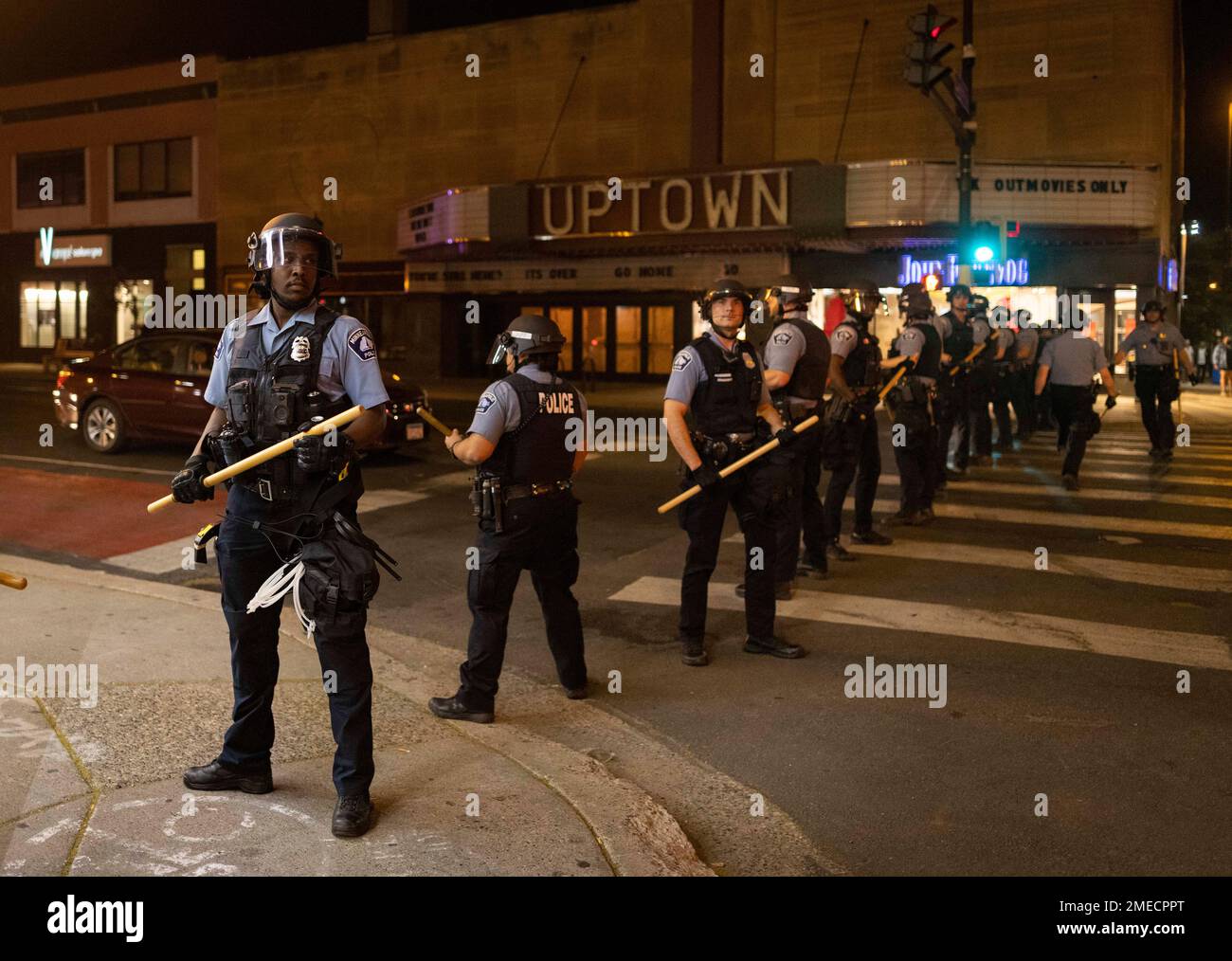 Minneapolis police officers stand in formation after a vigil for ...