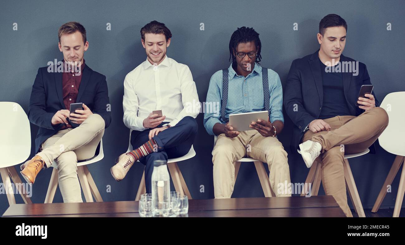Connected while we wait. a group of businessmen using different ...