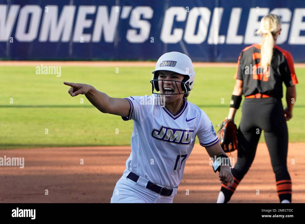 James Madison's Kate Gordon gestures to her dugout as she runs toward ...